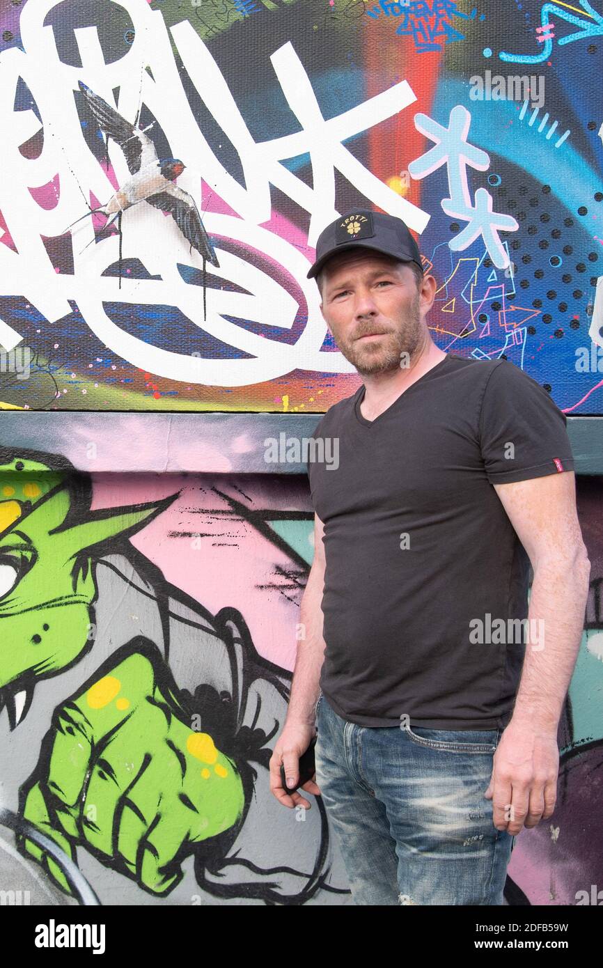 Street artist Zenoy is seen as a street art performance takes place to ...