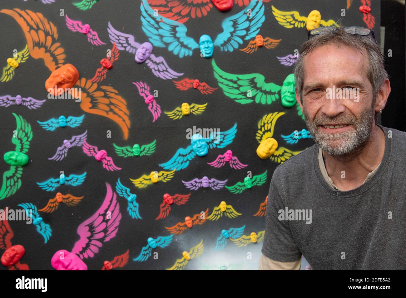 Street artist Gregos is seen as a street art performance takes place to ...