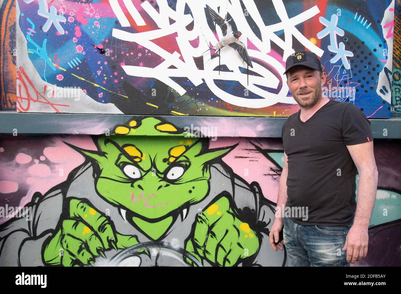 Street artist Zenoy is seen as a street art performance takes place to ...