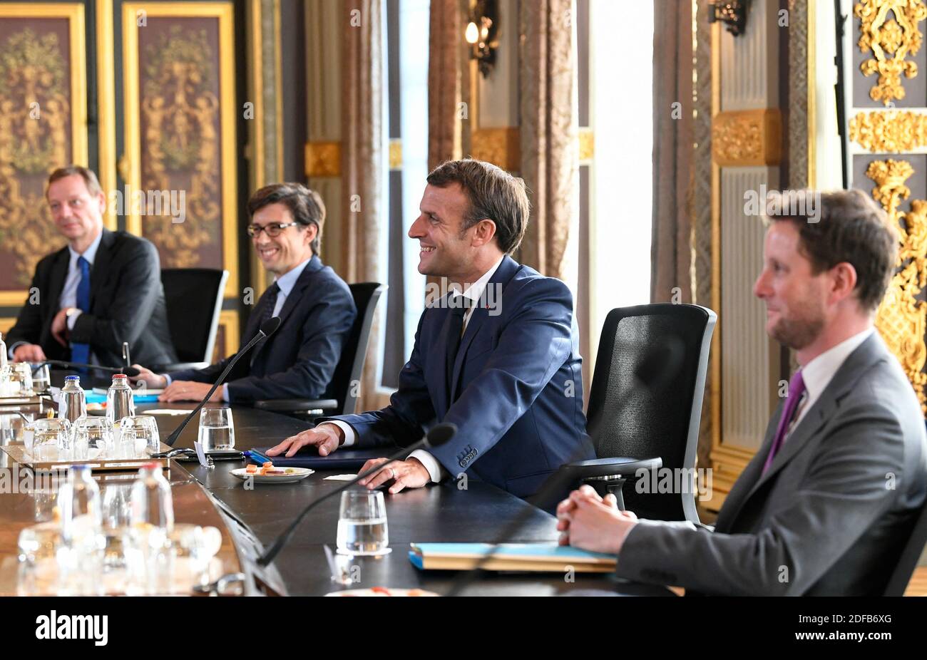 French President Emmanuel Macron reacts as he attends a meeting with ...
