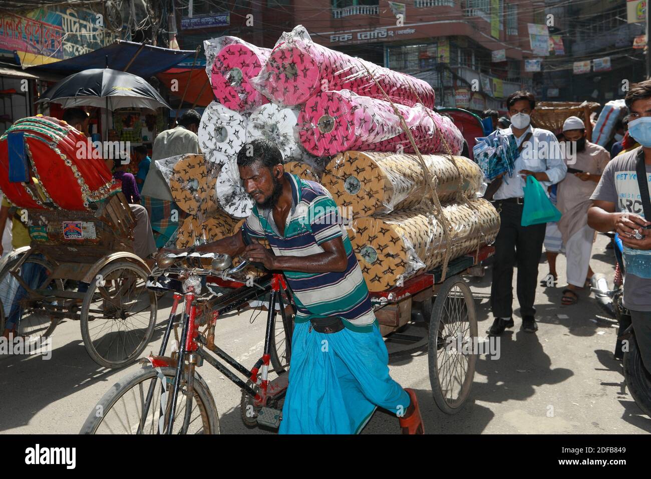 A Bangladeshi rickshaw van puller works during hot summer day without ...
