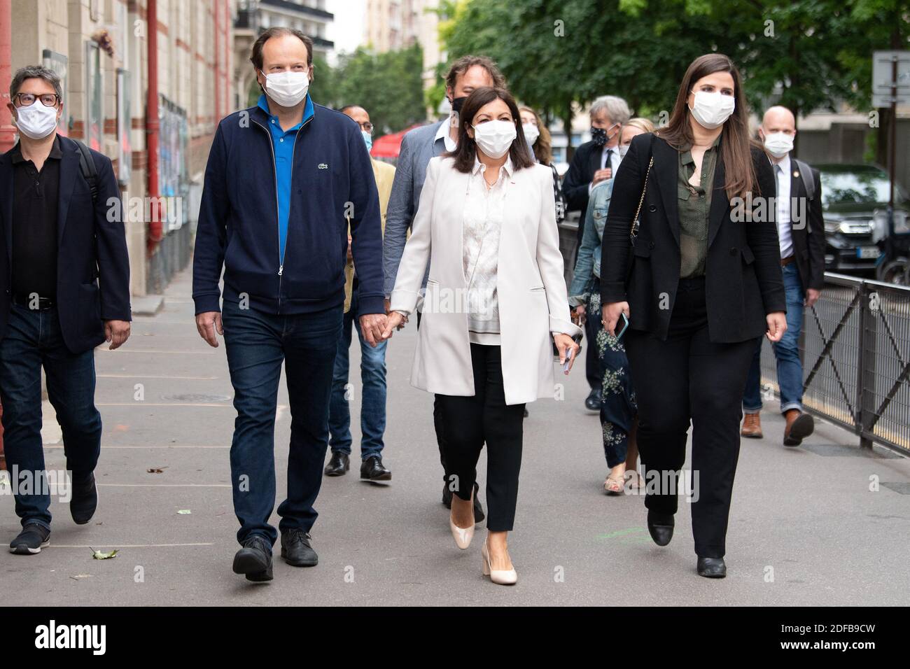 The incumbent mayor of Paris, Anne Hidalgo arrives with her husband ...