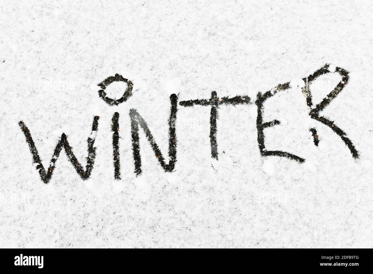 The word Winter written in snow. Snowy background Stock Photo - Alamy