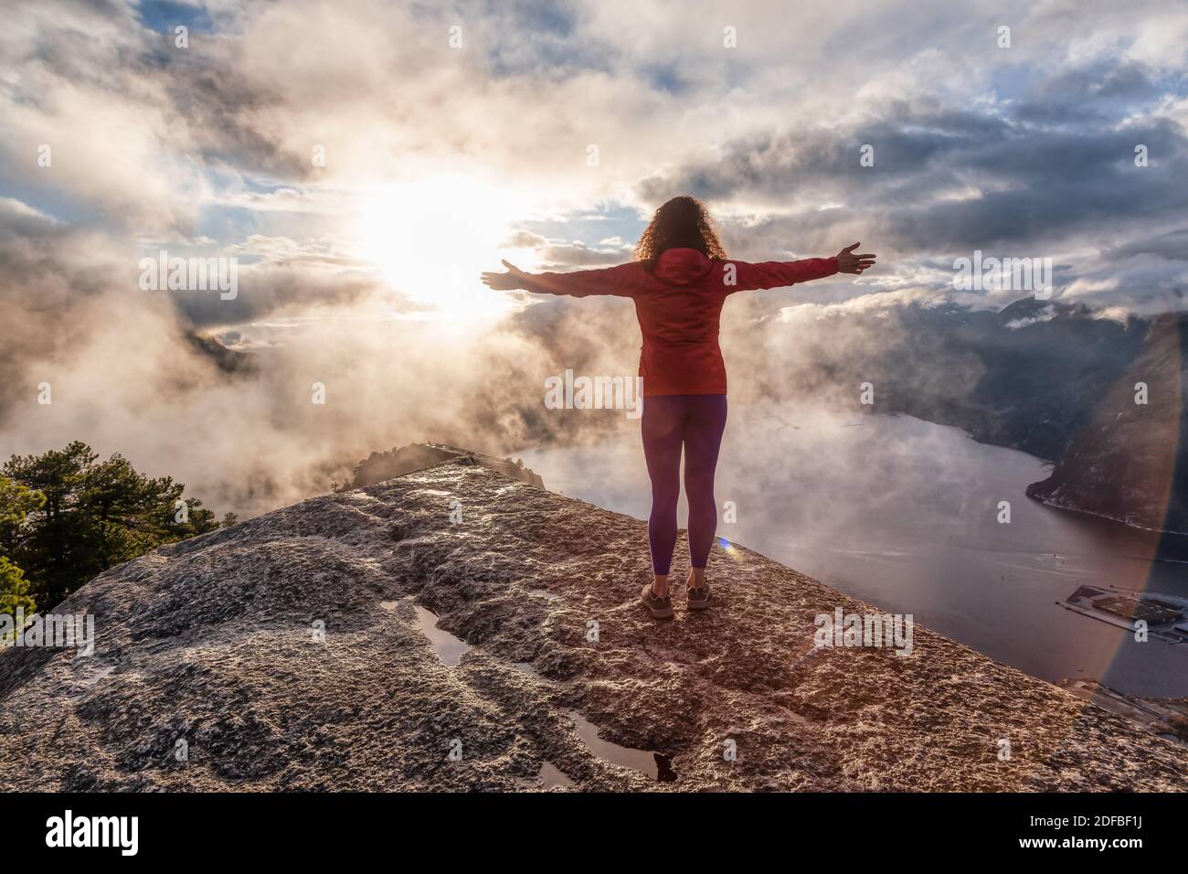Adventurous Girl Hiking on top of a Peak Stock Photo - Alamy