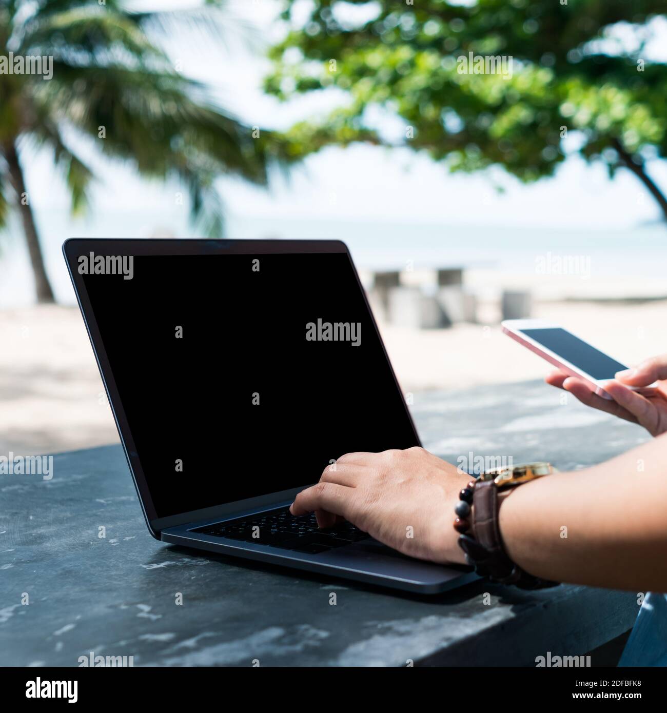 Woman using laptop and smartphone to work study in vacation cady at ...