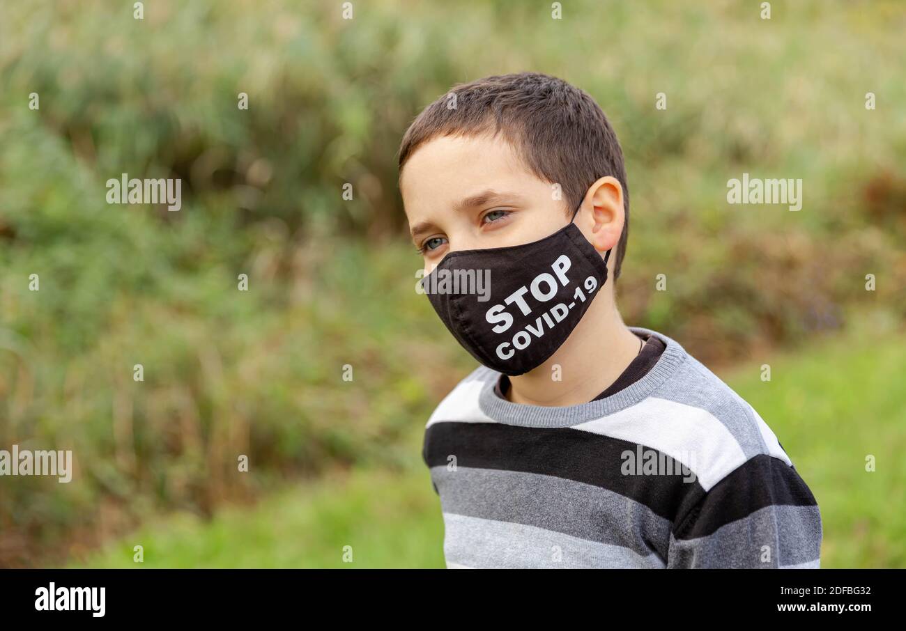 Sad and bored schoolboy kid with face mask feeling depressed Stock ...