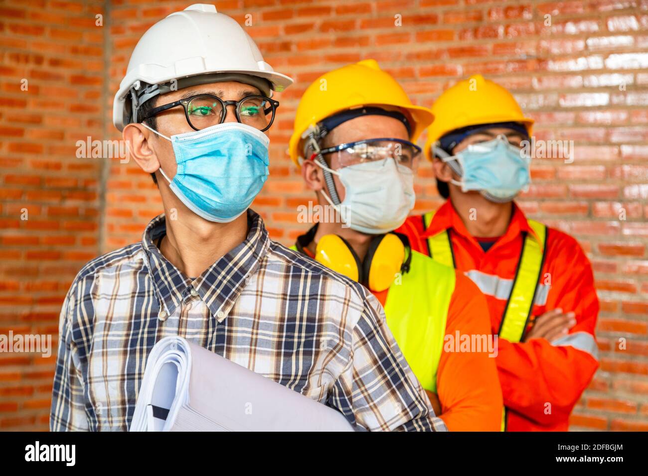 Team work construction engineers and three architects are ready to wear ...