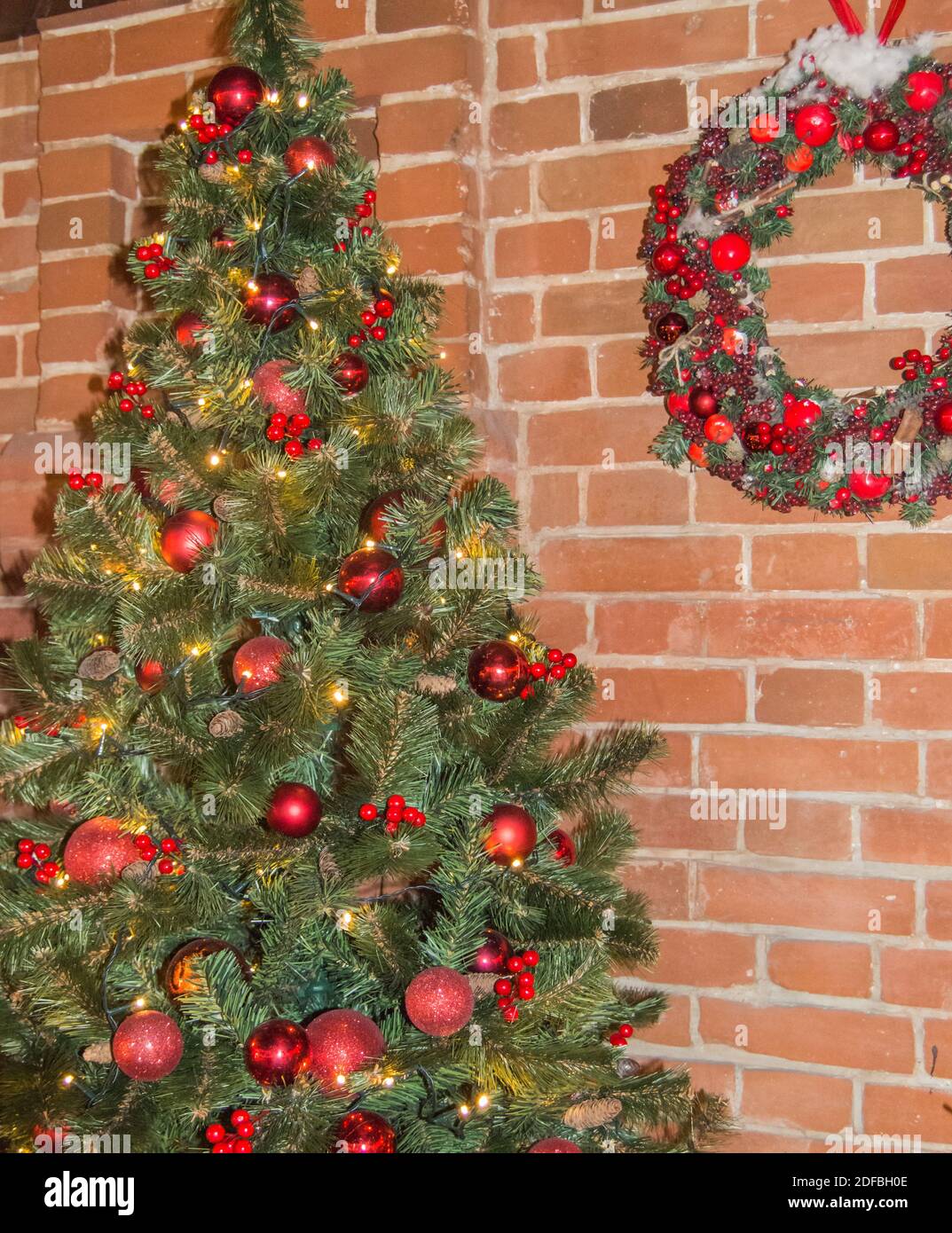 The red brick wall of the house is decorated for Christmas. Christmas ...