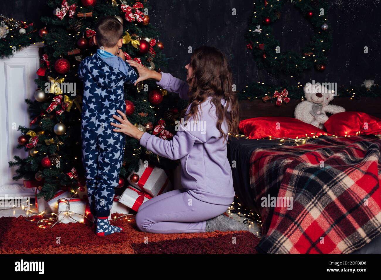 Mom And Boy Decorates Christmas Tree Christmas New Year Stock Photo Alamy