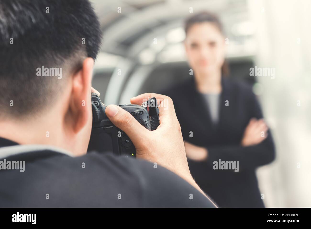 Back view of photographer taking picture of businesswoman Stock Photo ...