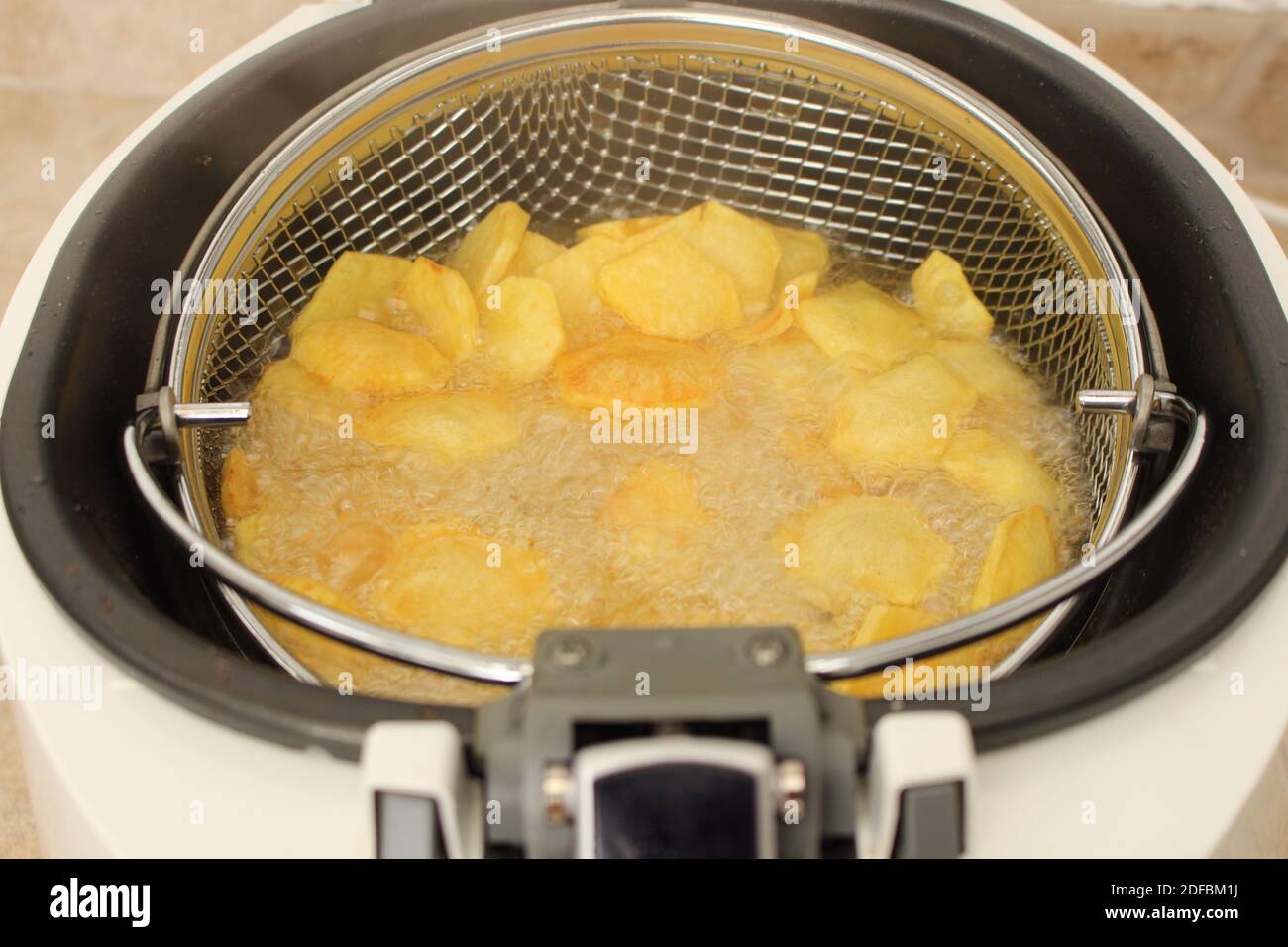 fresh crispy french fries from the deep fryer Stock Photo - Alamy