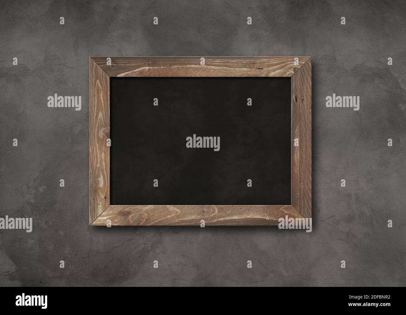 Old rustic black board isolated on a dark concrete background. Blank ...