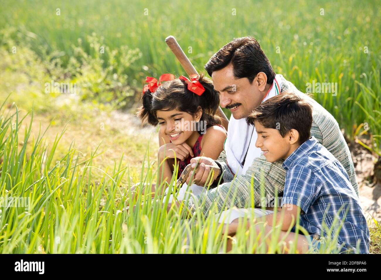 Happy rural family farming in agricultural field Stock Photo - Alamy