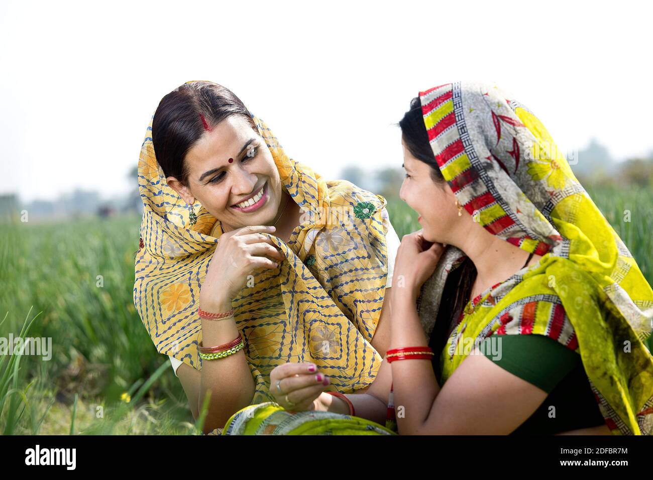 Two happy indian rural women talking on agricultural field Stock Photo ...