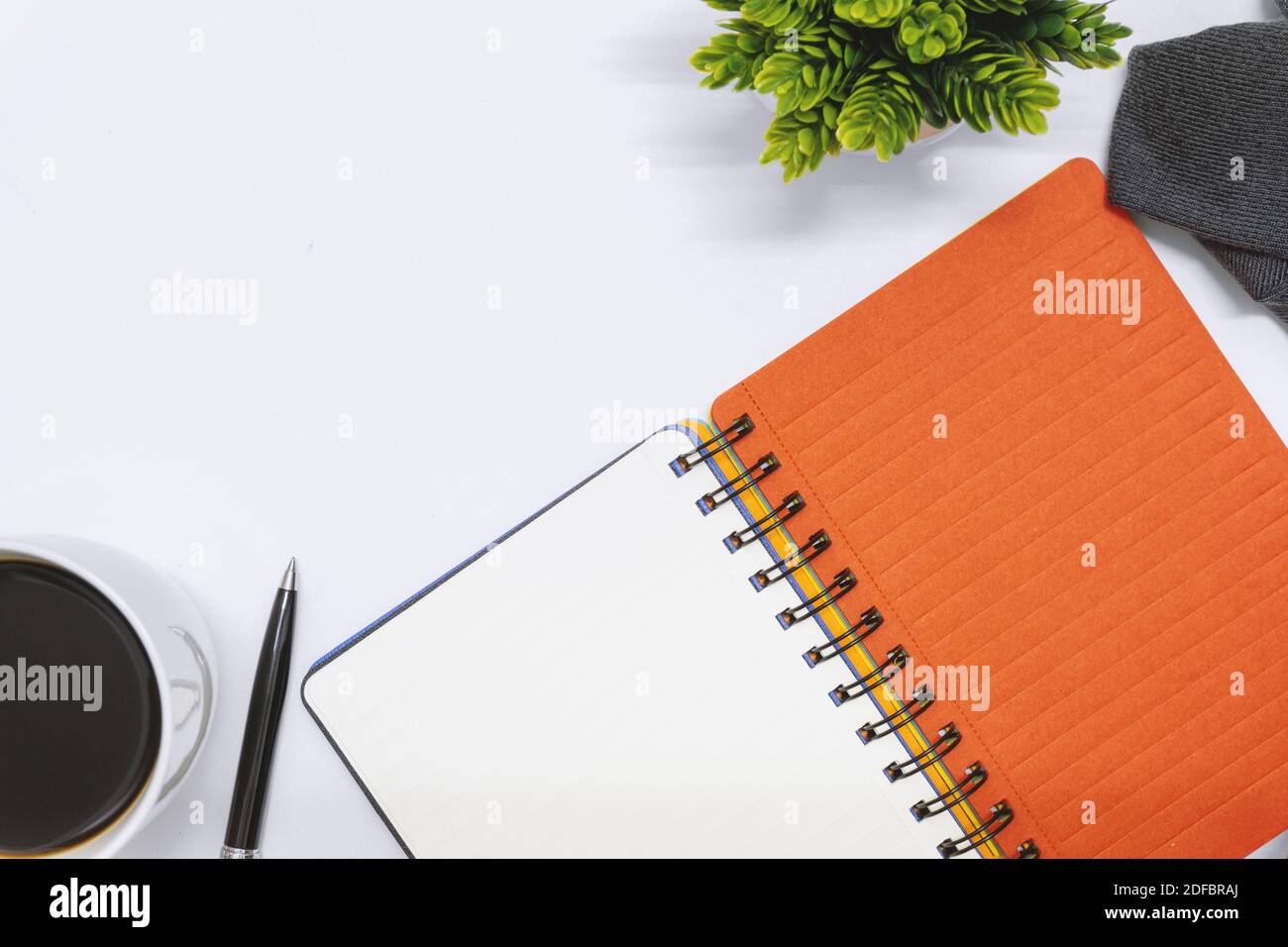 Overhead view of notebook on white desk Stock Photo - Alamy
