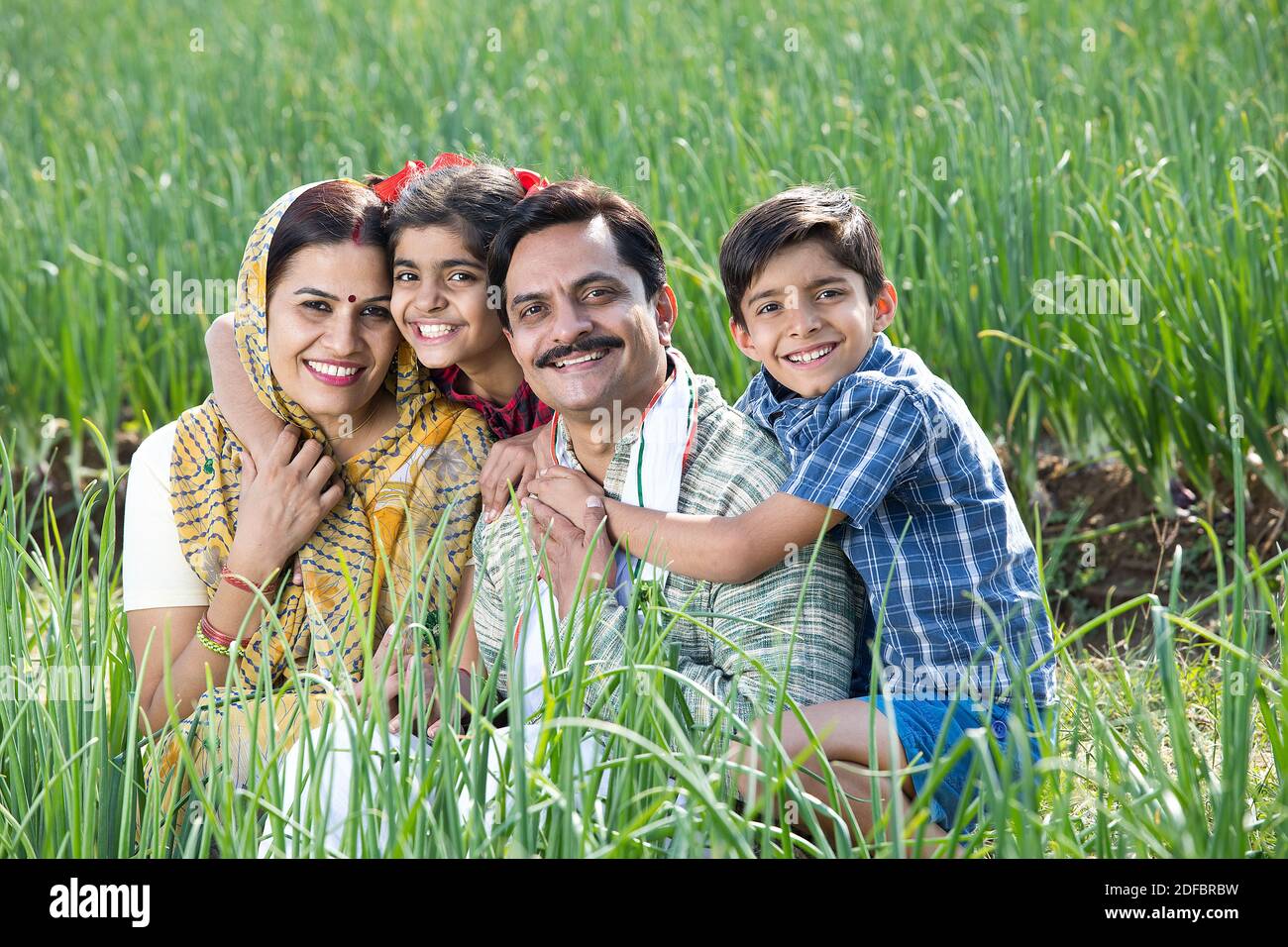 Rural family of farmer on agriculture field Stock Photo - Alamy