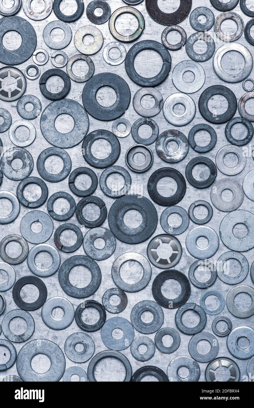 Washers on metallic background top view Stock Photo - Alamy