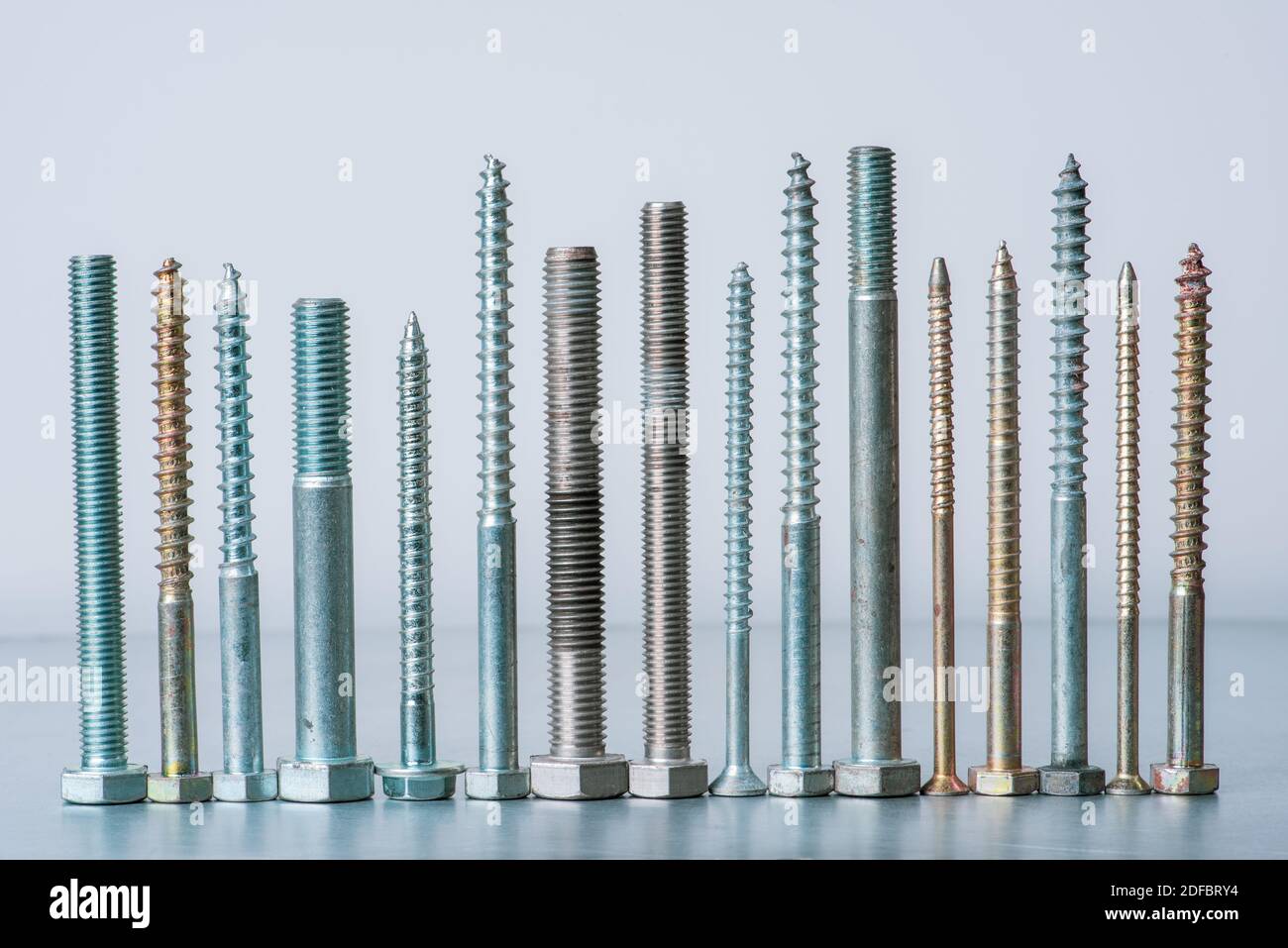 Row of steel bolt and screws in workshop Stock Photo - Alamy