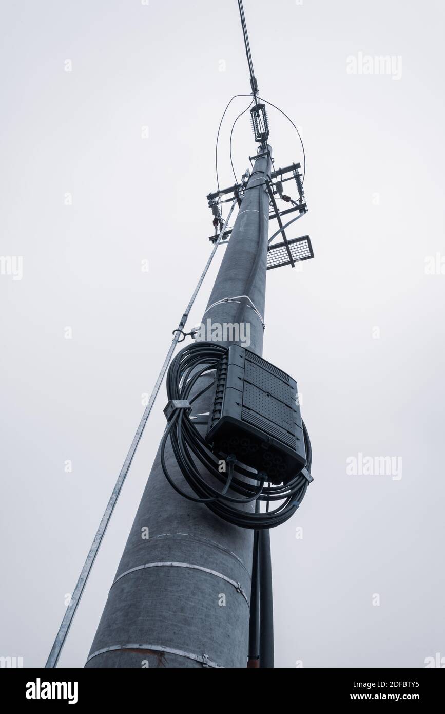 Electric pole with fiber optic muff Stock Photo - Alamy