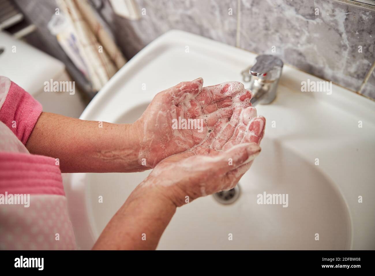 Elderly Woman Washing Hands High Resolution Stock Photography and ...