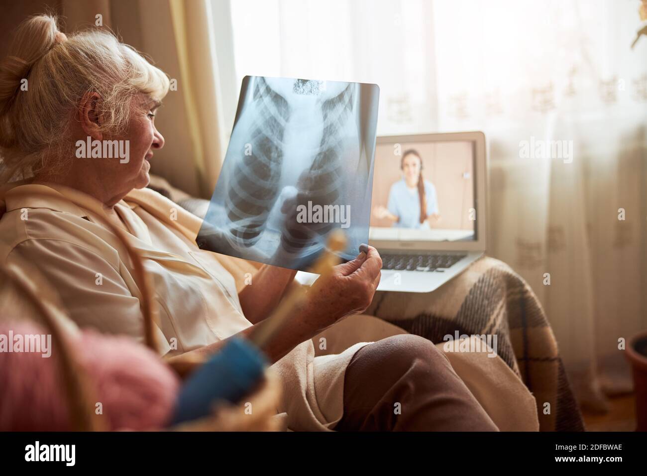 Elderly woman having online consultation with doctor at home Stock ...