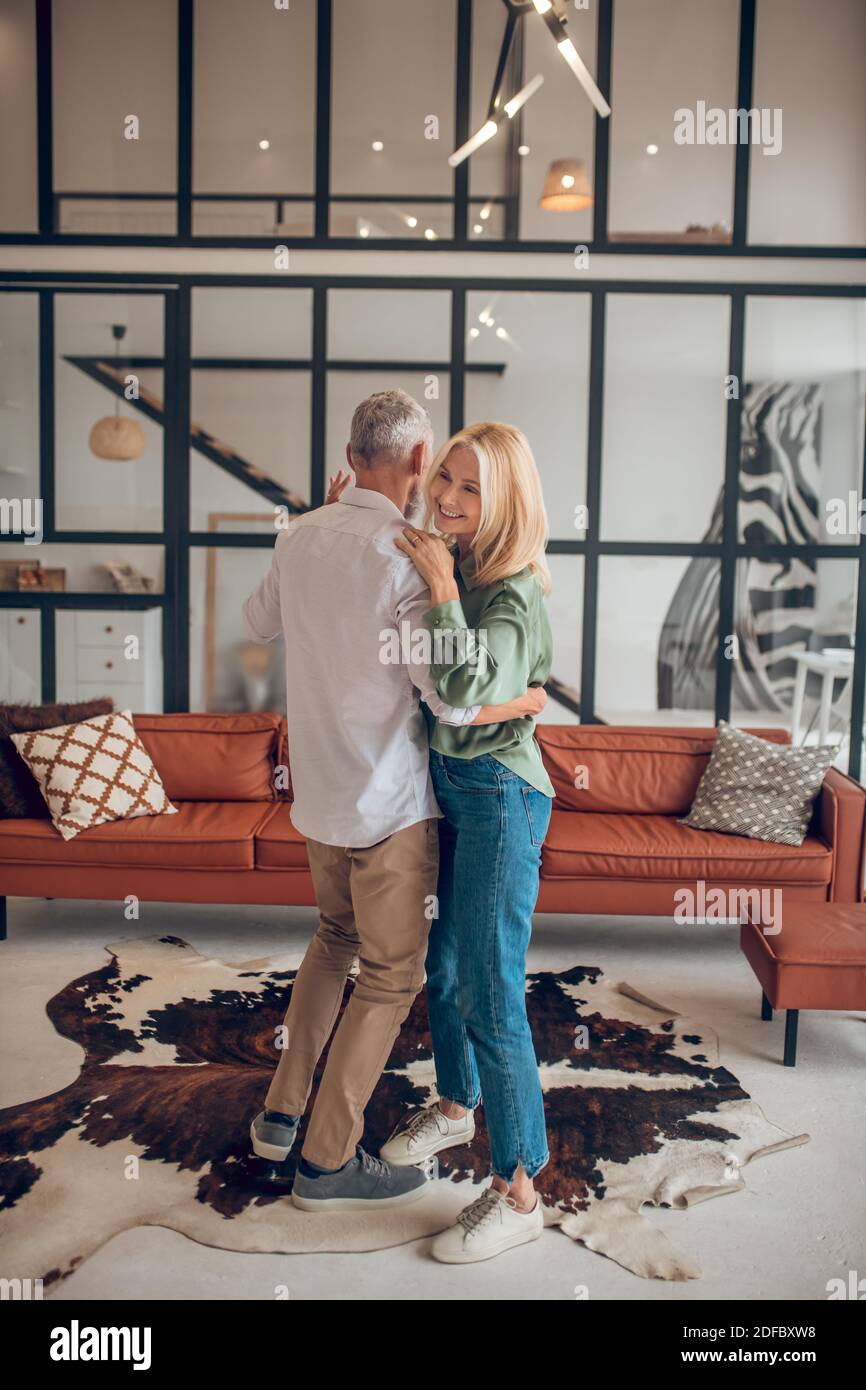Mature couple dancing in the room and looking happy Stock Photo - Alamy