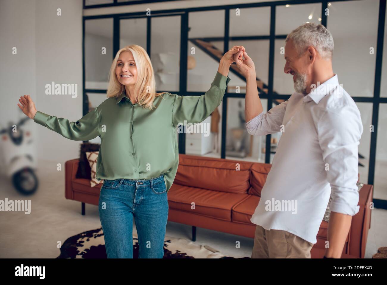 Man and woman dancing in the room and feeling good Stock Photo - Alamy