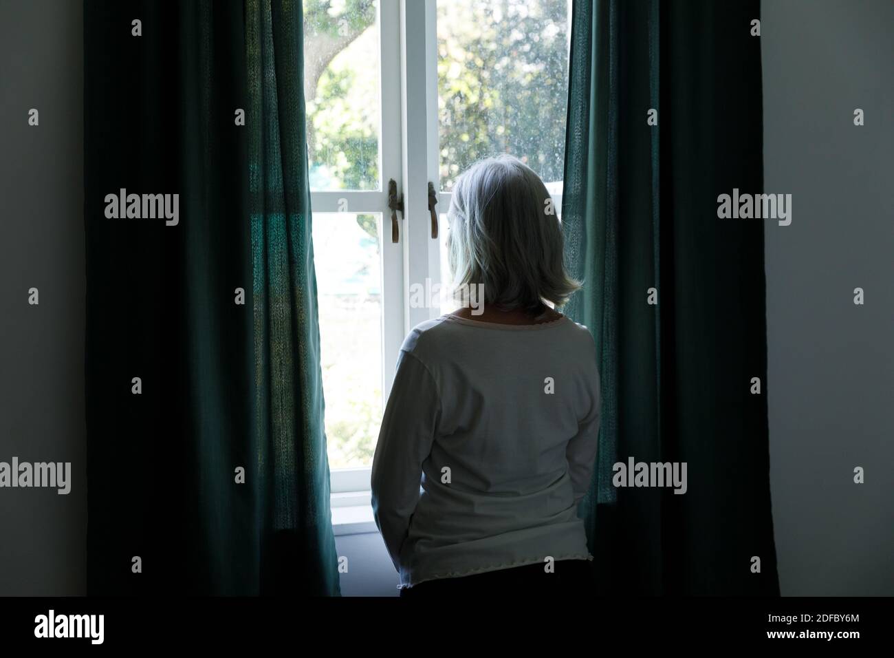 Rear view woman looking window hi-res stock photography and images - Alamy