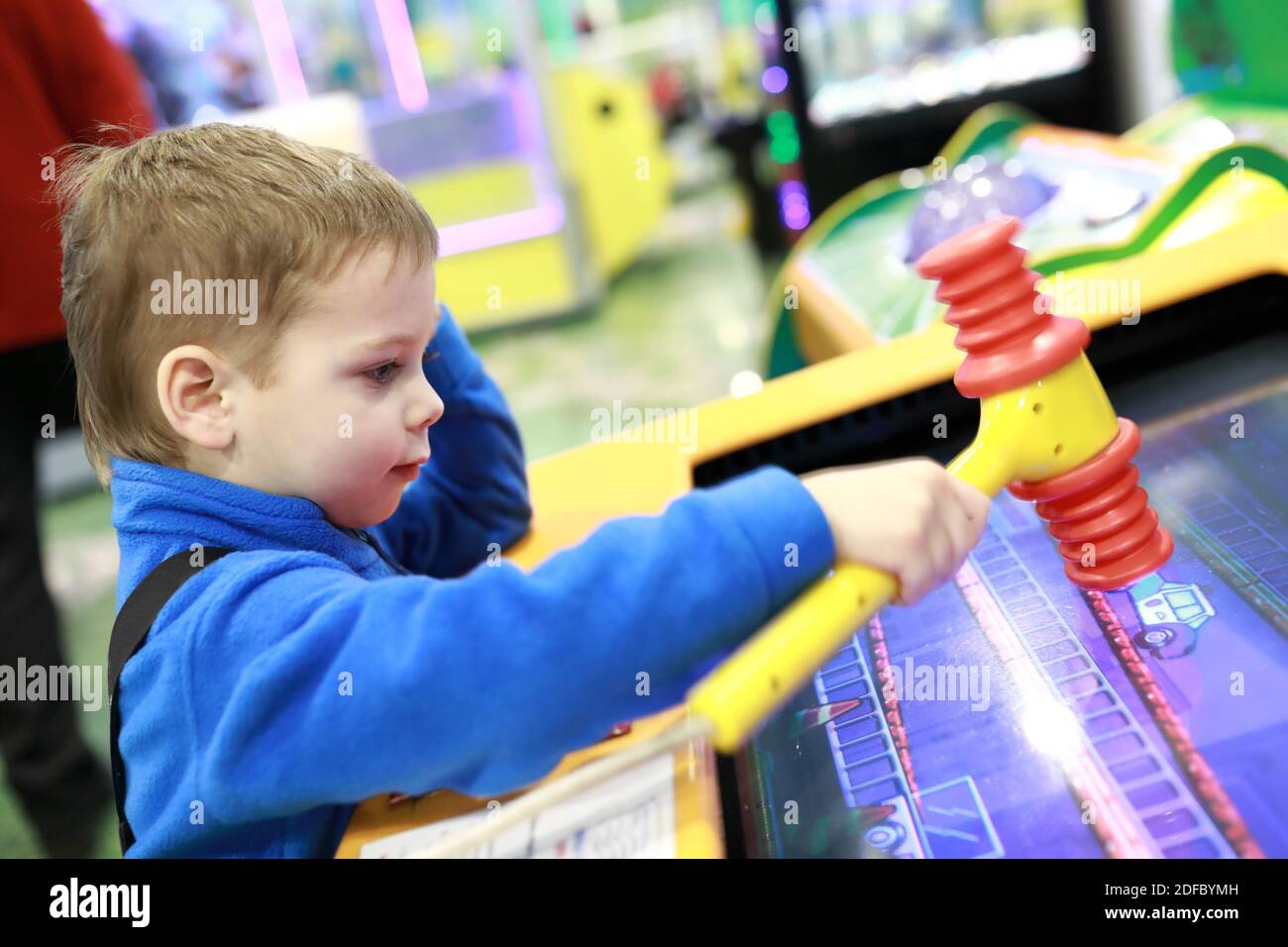 Child playing arcade game with hammer in amusement center Stock Photo ...