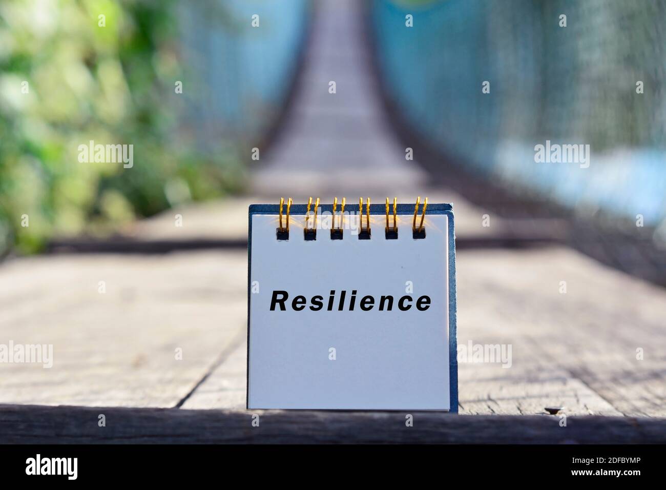 Resilience text written on white note with blurred background of ...