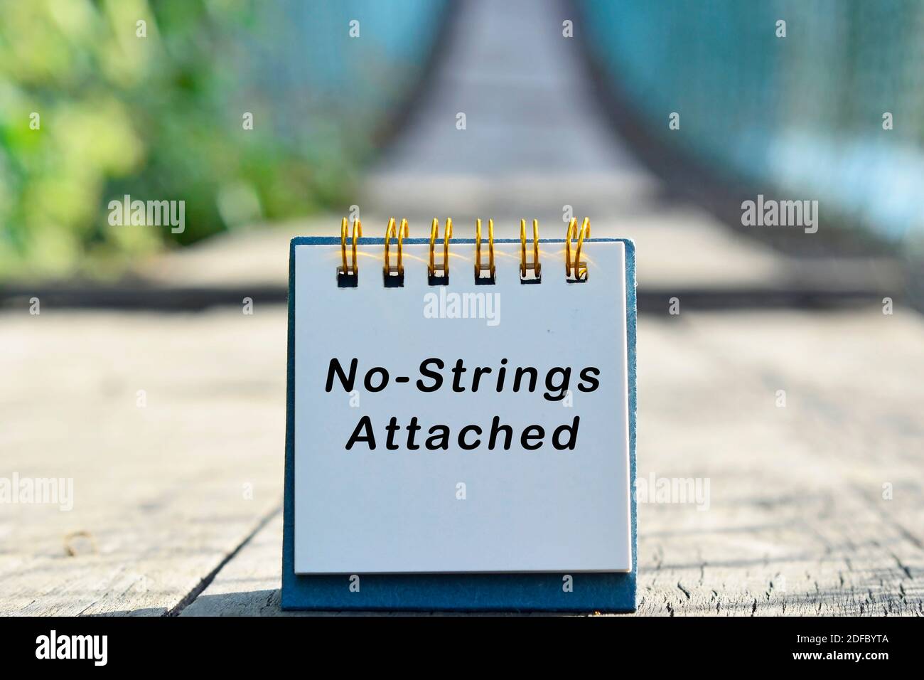 No strings attached text written on white note with blurred background ...