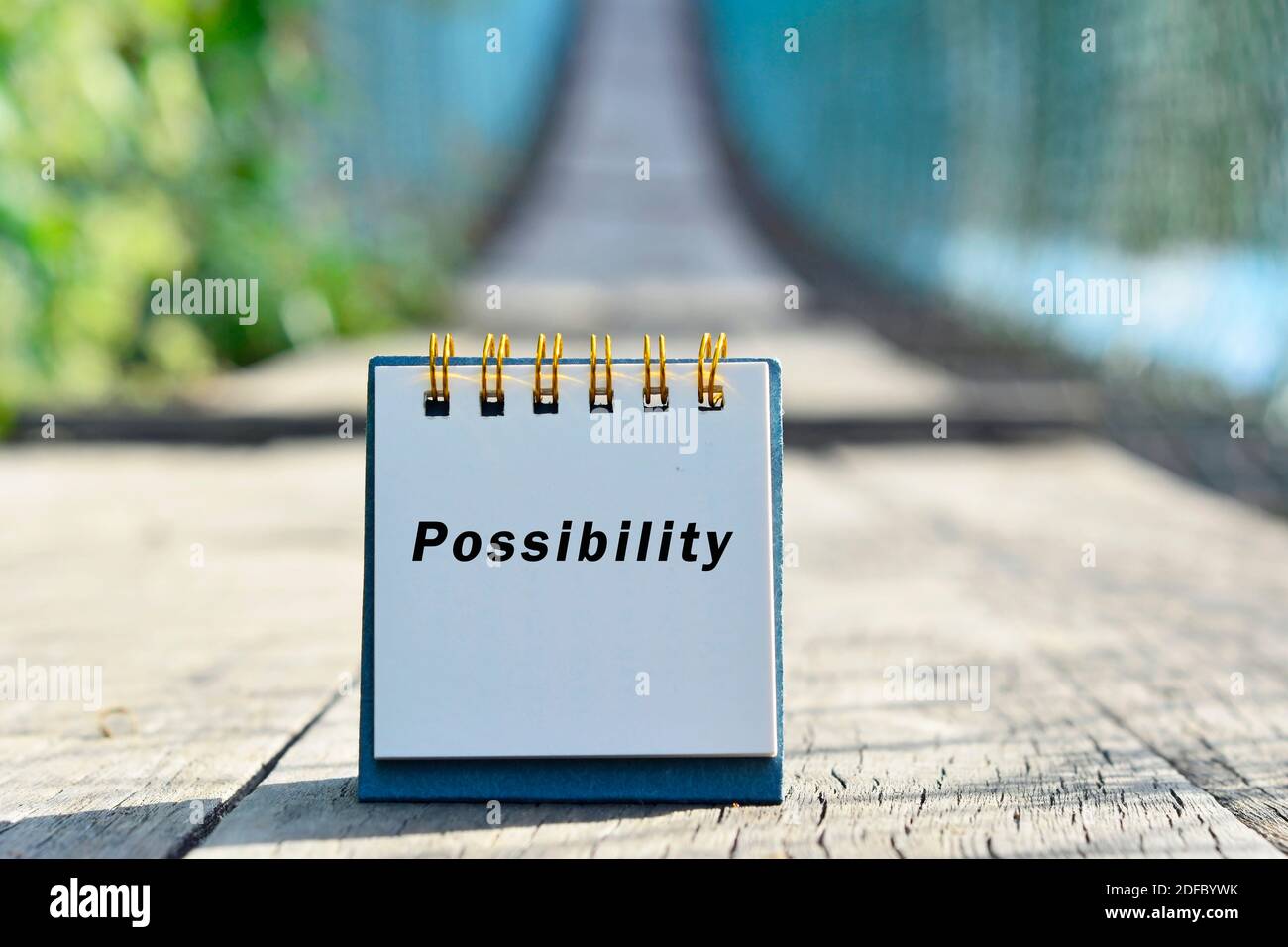 Possibility text written on white note with blurred background of ...
