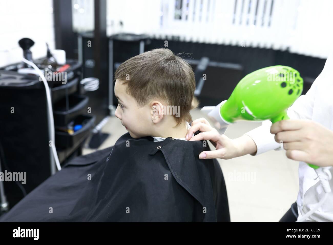 Child having haircut at the barbershop Stock Photo - Alamy