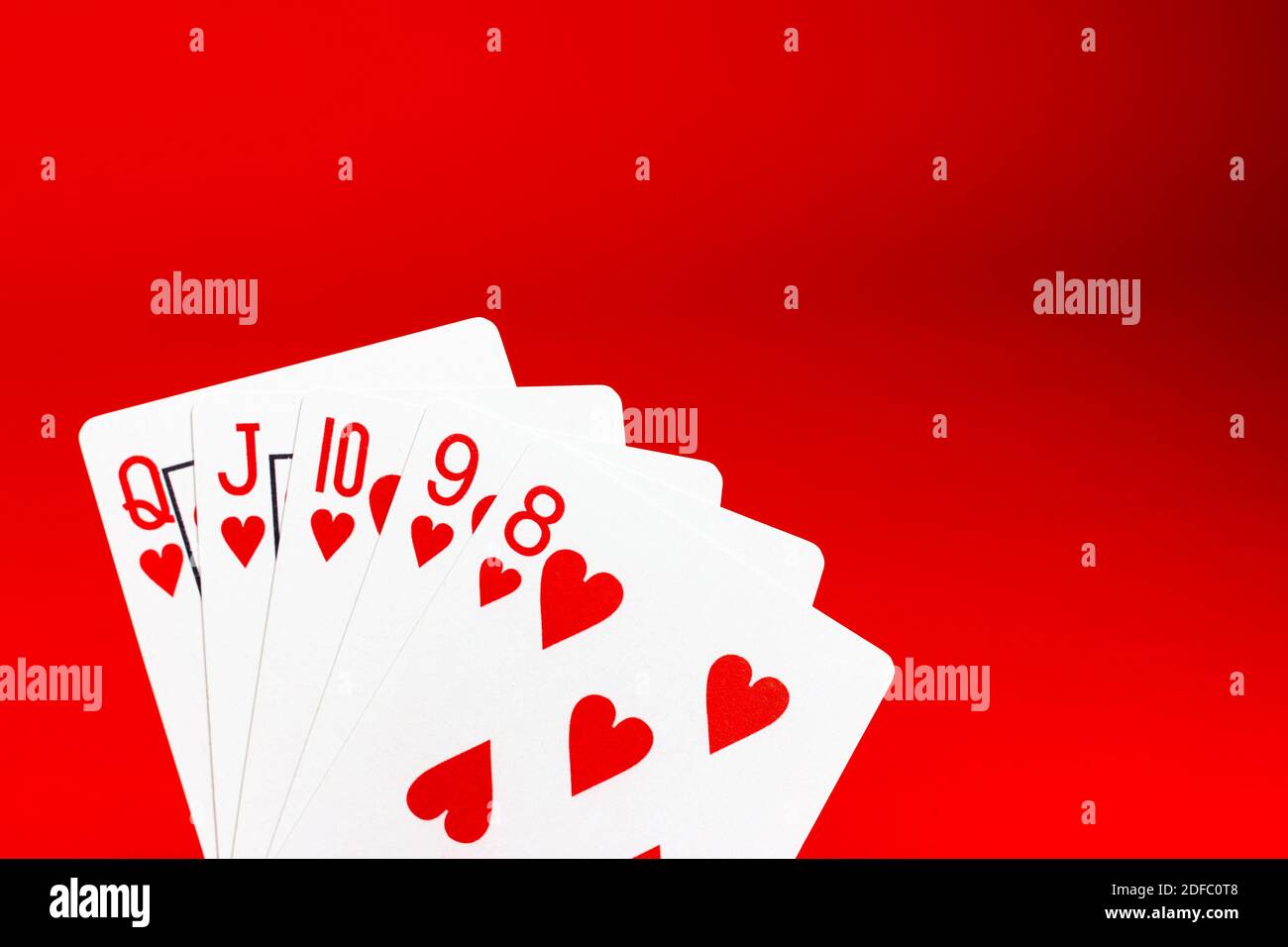 Playing cards on a red background. Strong combination - royal flush ...