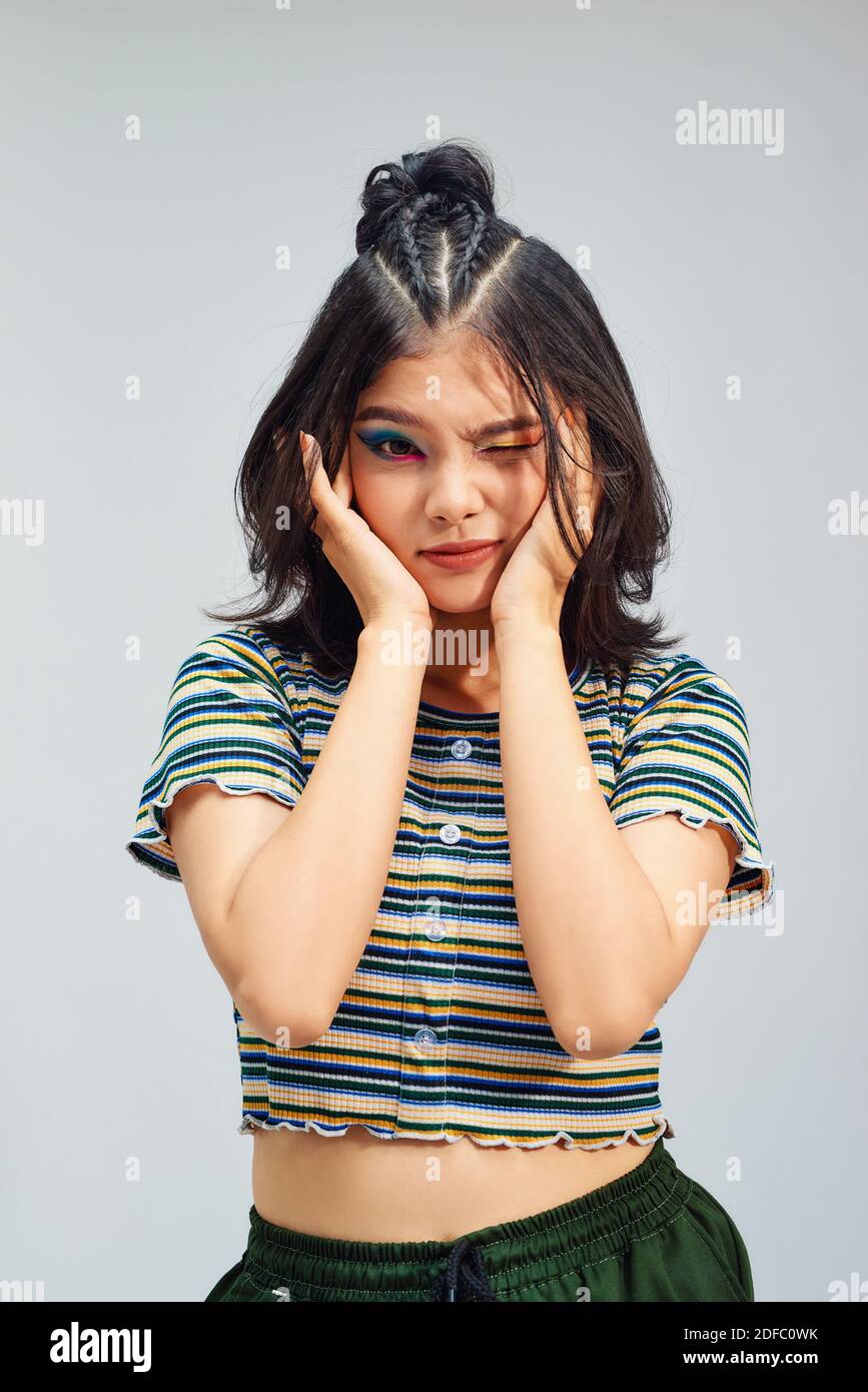 Cute young female with delicate features blinking her eyes with ...