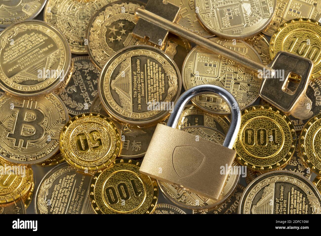 A top view shot of a heap of coins and a padlock - concept of financial ...