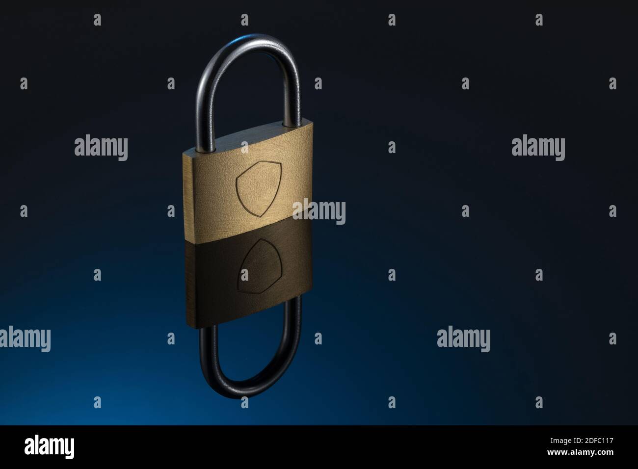 A padlock with a shield on it put on a reflecting surface - security ...
