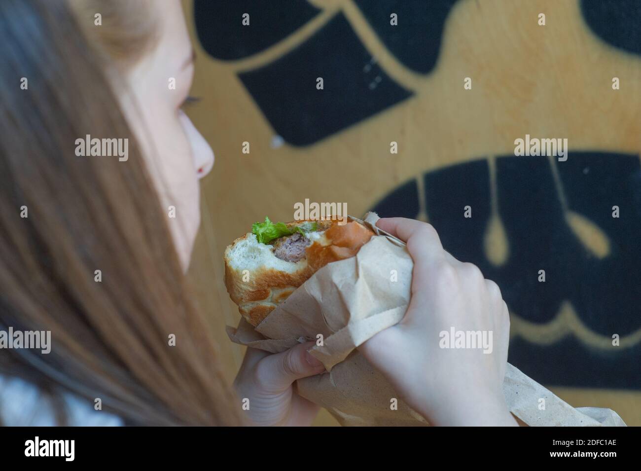 Teenager Eating A Burger. Teen girl eating burger. Fast food Stock ...