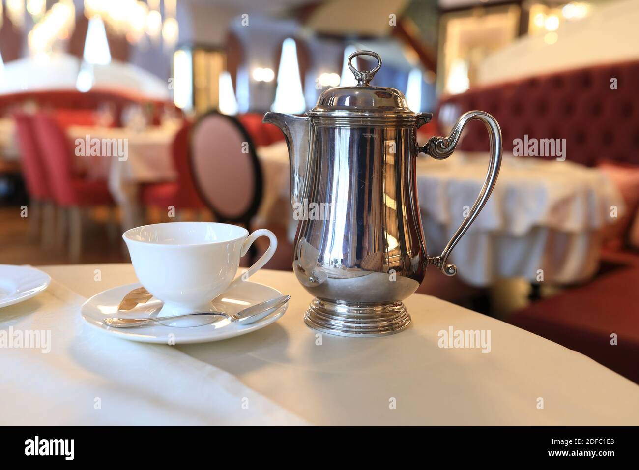Metal teapot and tea cup in restaurant Stock Photo - Alamy