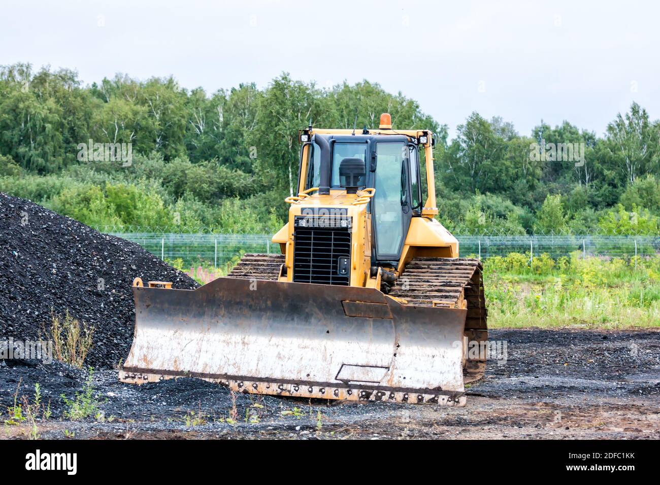 Bulldozer dredges rubble on road construction Stock Photo - Alamy