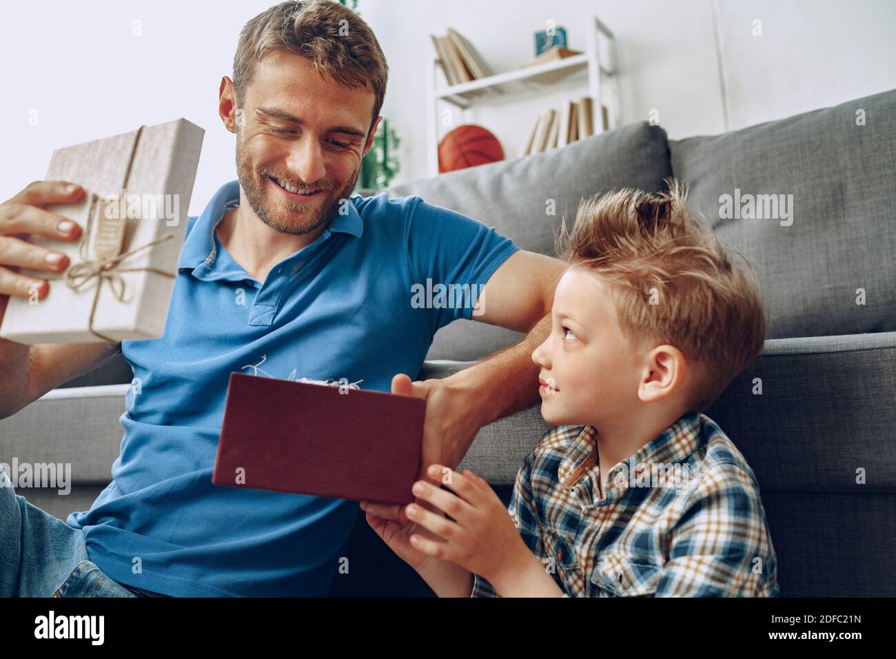 Little son gives his father a gift box for father's day Stock Photo - Alamy