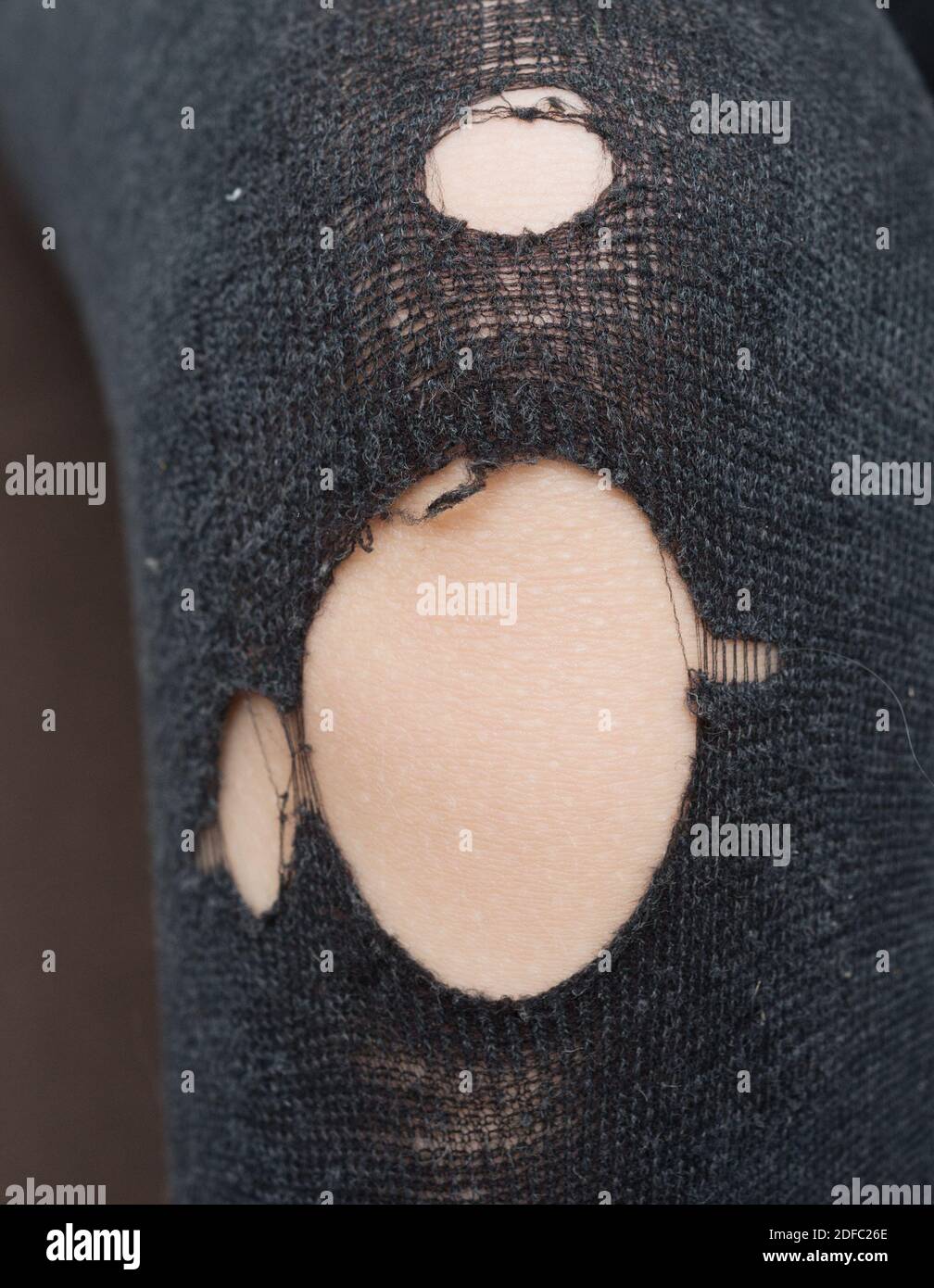 Hole on the clothes Stock Photo - Alamy