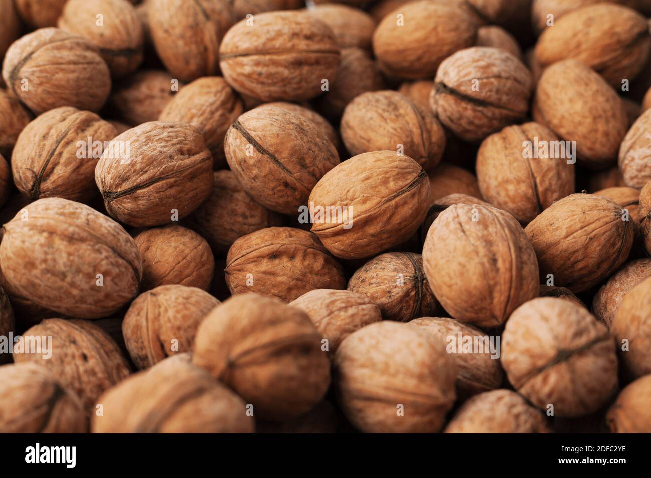 Heap of walnut in a shell background texture of a Stock Photo - Alamy