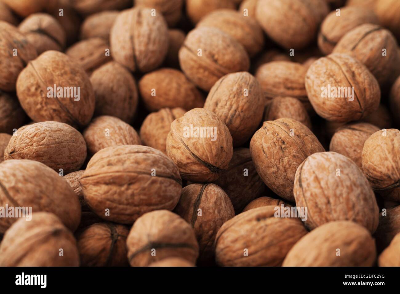 Heap of walnut in a shell background texture of a Stock Photo - Alamy