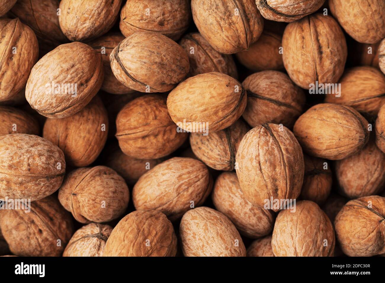 Heap of walnut in a shell background texture of a Stock Photo - Alamy