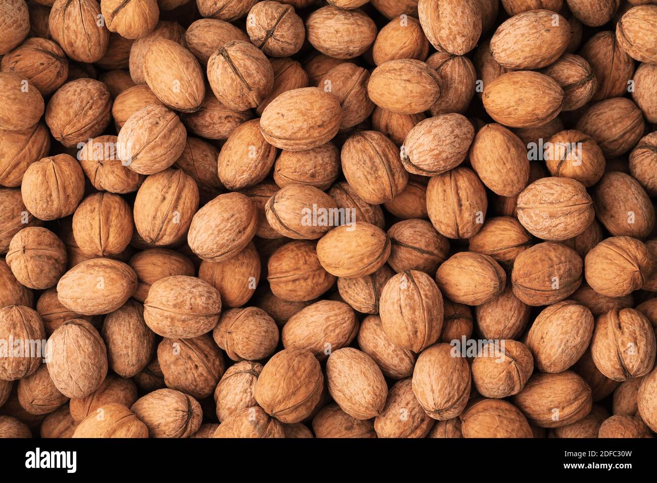 Heap of walnut in a shell background texture of a Stock Photo - Alamy