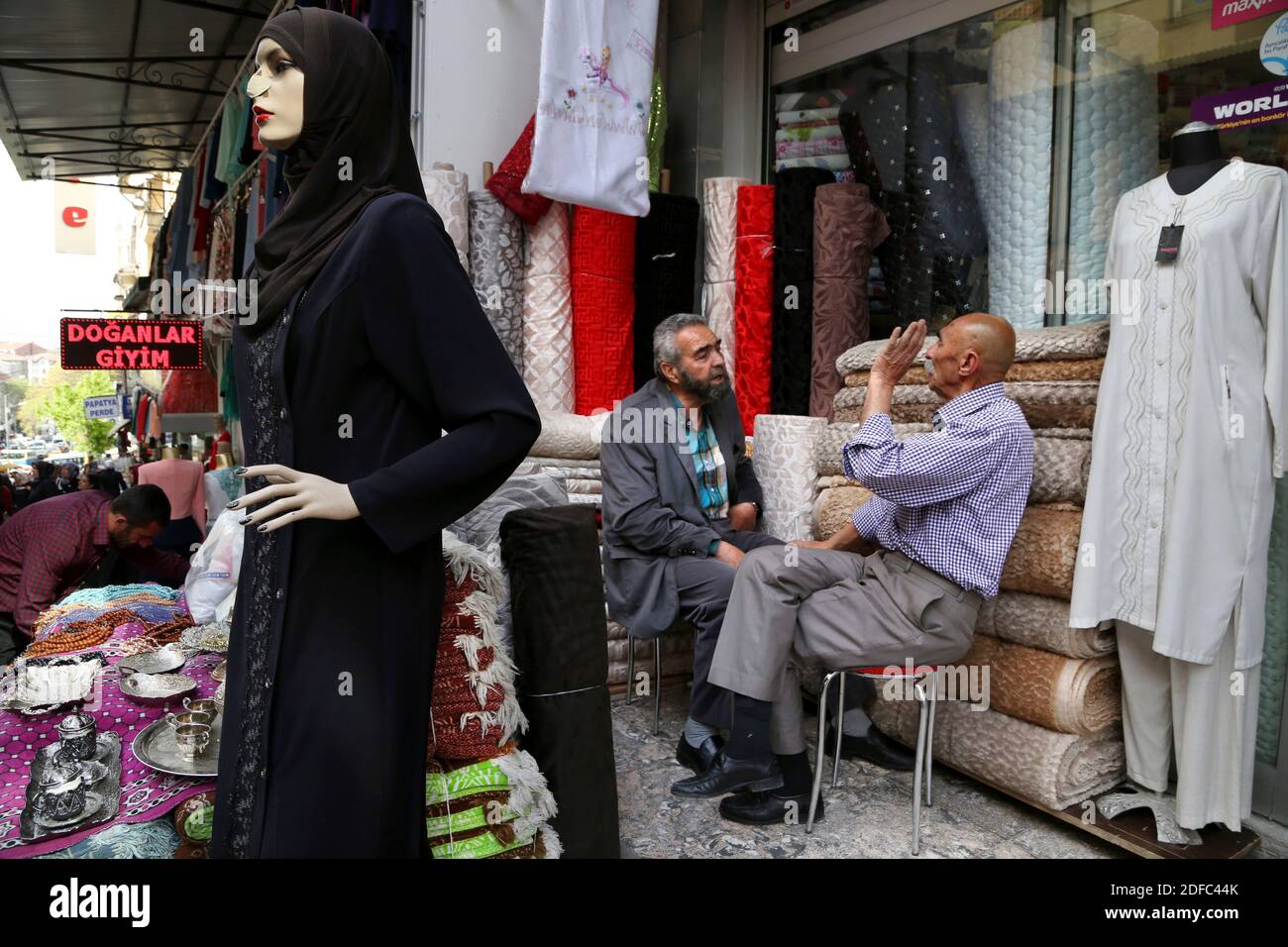 Turkey, Kurdish men in a street of Mardin with mannequin wearing niqab ...