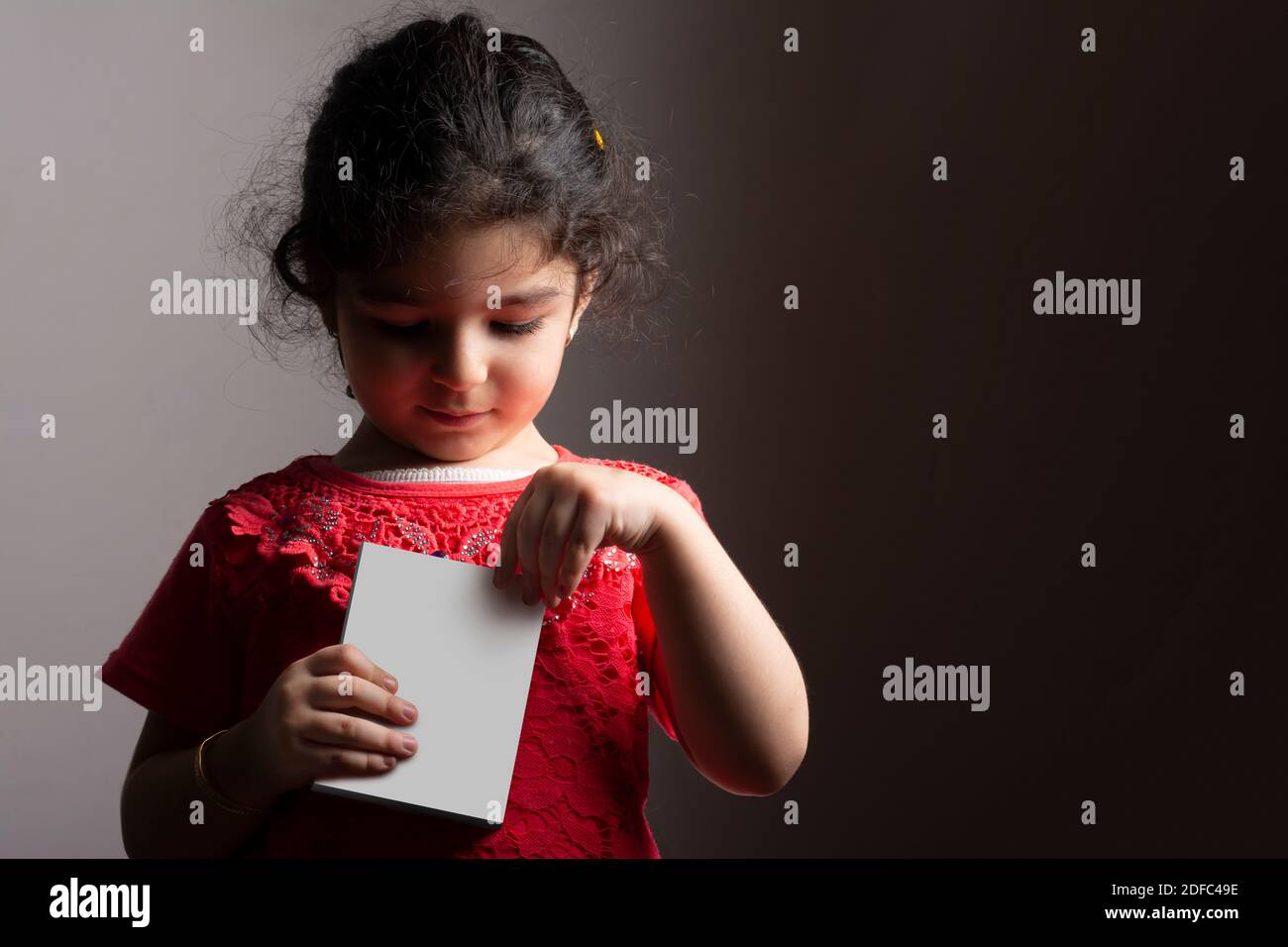 Little girl opening a small box in front of body, editable mock-up ...