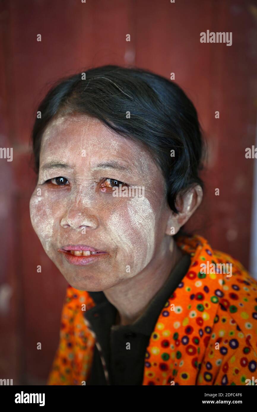 Myanmar (Burma), portrait of woman with thanaka powder on her face in ...