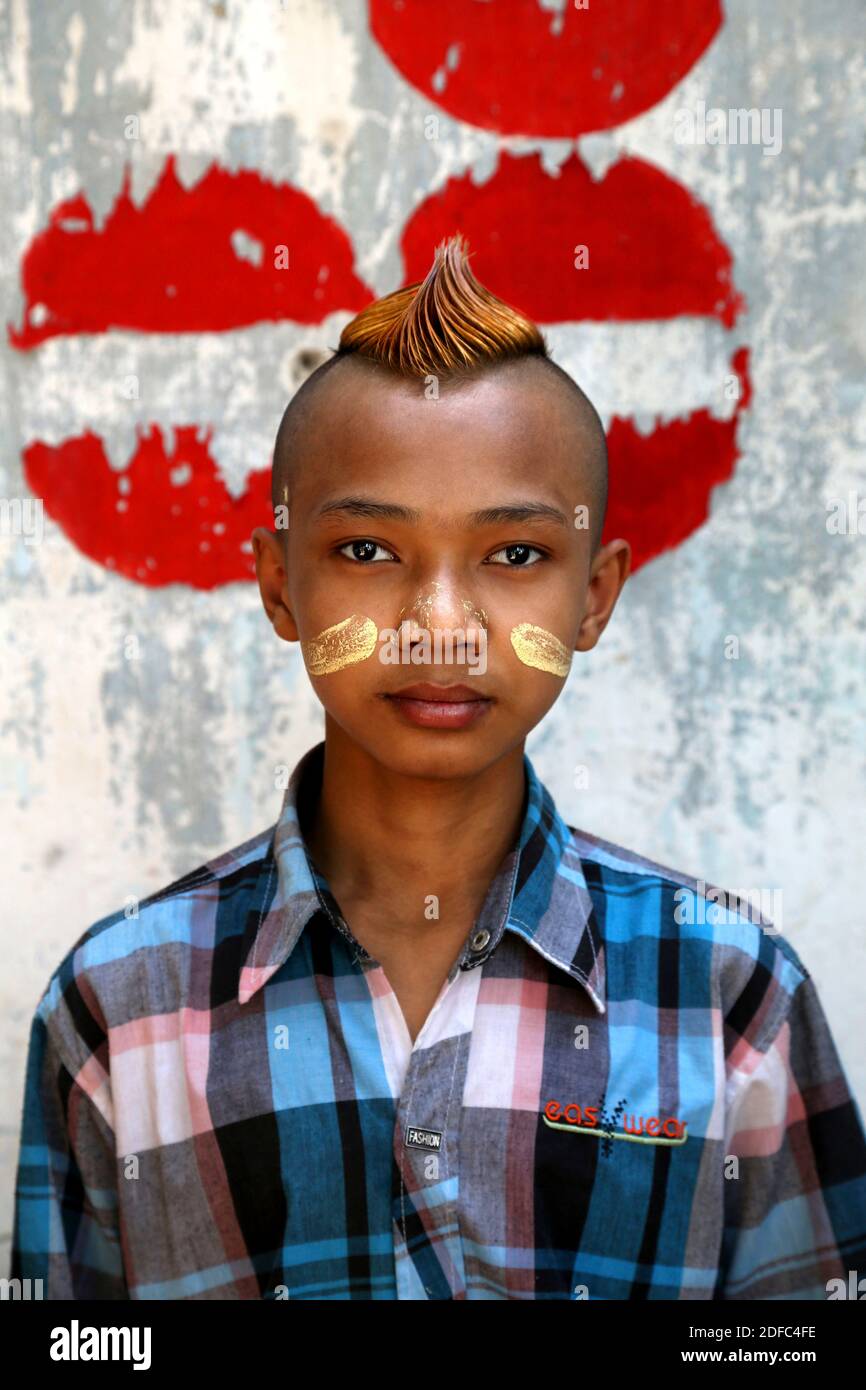 Myanmar (Burma), Mandalay, young man wearing thanaka powder on his face ...